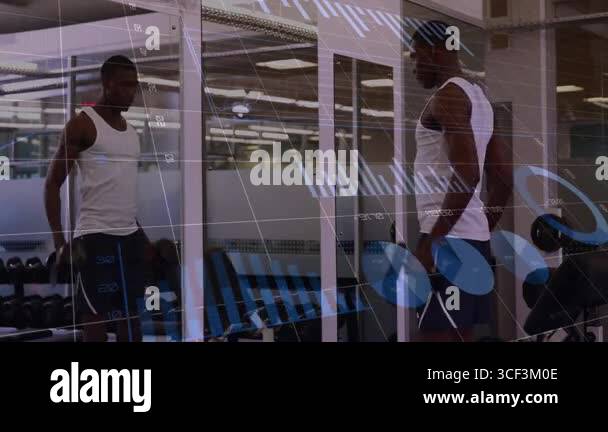 Man gripping weights at shoulder pressing upward in fitness gym with ...