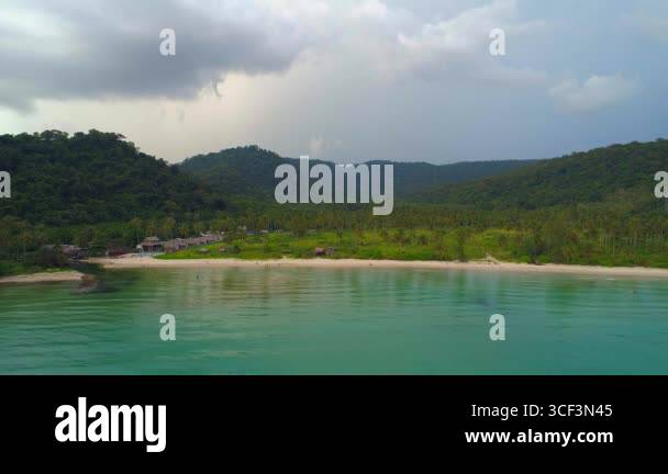 Thunderstorm transforms serene beach in Koh Kood, Thailand. Dark clouds ...