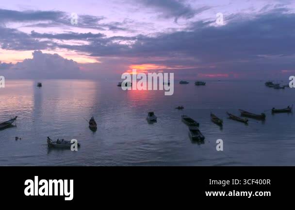 Stunning Thai sunset over Koh Tao, white boat sailing along colorful ...
