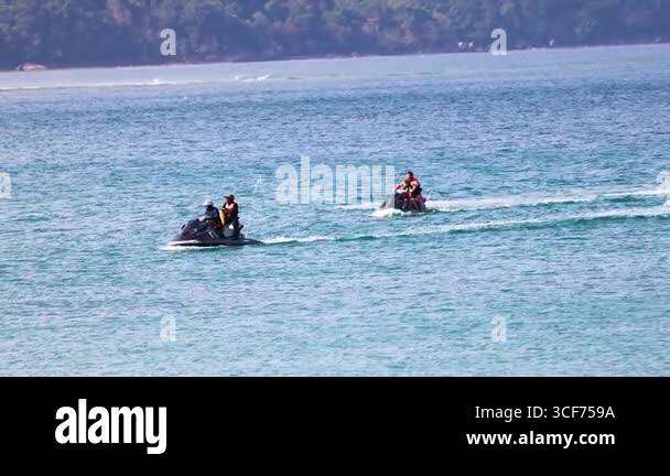 Two people enjoying a jet ski ride Stock Video Footage - Alamy