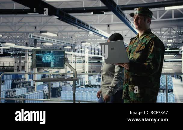Soldier in server hub using laptop to deploy AI tech, modernizing ...