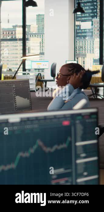 Vertical video Traders in prop firm office follow breaking news TV ...