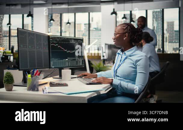 Day trader analyzes stock exchange price candlestick graphs, making buy ...