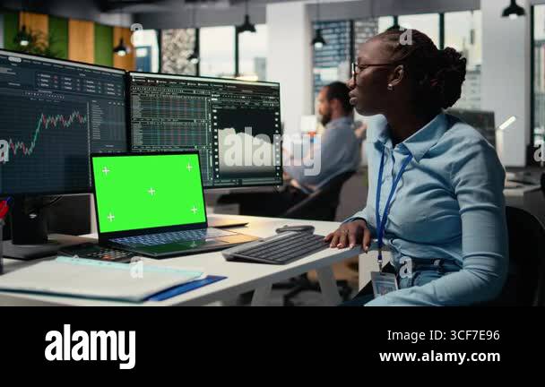 Financial analyst at work doing research on stock market shares using ...