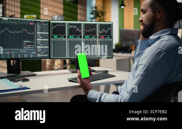 Equity analyst using green screen smartphone to reviews quarterly ...