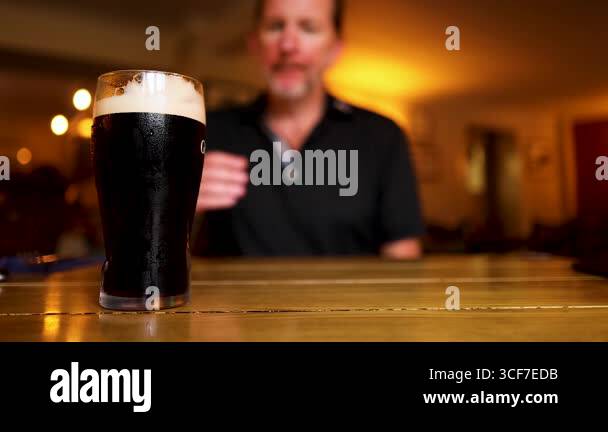 Man grabs and drinks a pint of stout Stock Video Footage - Alamy