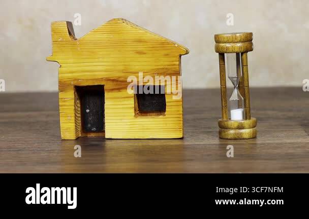 Miniature house and hourglass depict the concept of property time Stock ...