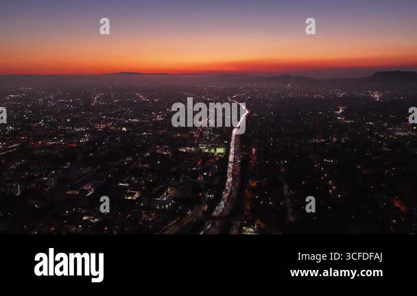 Aerial drone footage of Los Angeles during sunset, showing a glowing ...