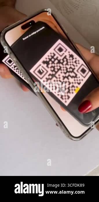 Young woman scanning a QR code on another device. Digital shopping concept. Ideal for online ...
