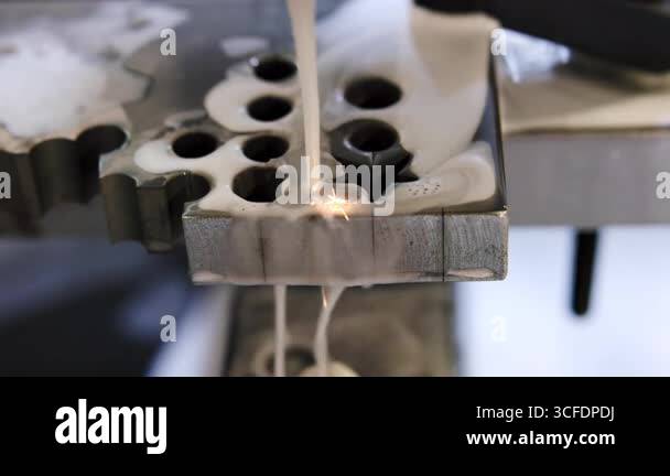 Molten metal drips from a metal plate during industrial laser cutting ...