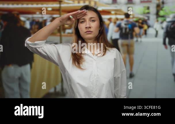 Woman saluting in a bustling outdoor city market with diverse shoppers ...