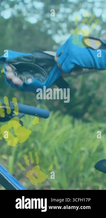 Animation of handprints over caucasian man cycling. global sport and ...