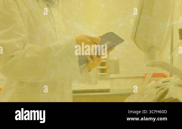 Female lab technician marking clipboard notes with stylus, reviewing ...