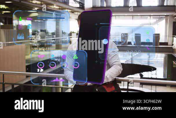 Businessman raising hand conjuring hologram smartphone rotating inspecting data charts then ...