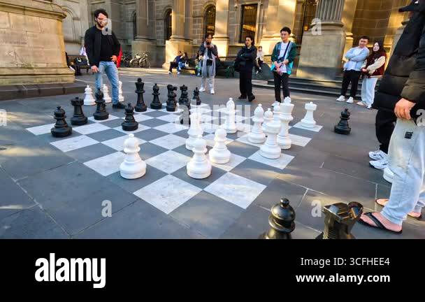 People engaged in a giant chess game outdoors Stock Video Footage - Alamy