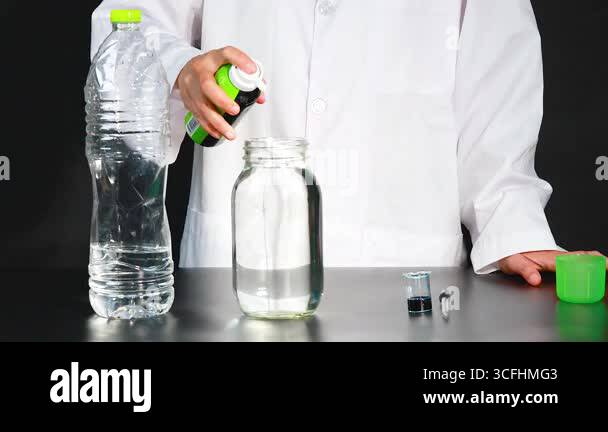 A person in a lab coat performs a chemical reaction using shaving cream ...