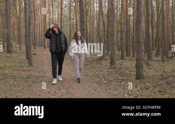A young couple on a thoughtful walk, seriously contemplating a shared ...