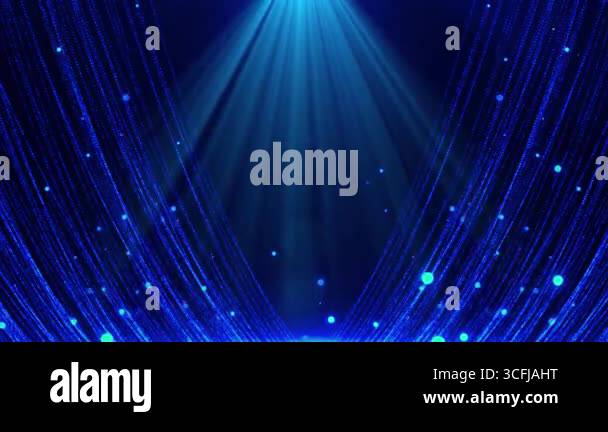 A vibrant blue stage with beams of light and floating particles ...