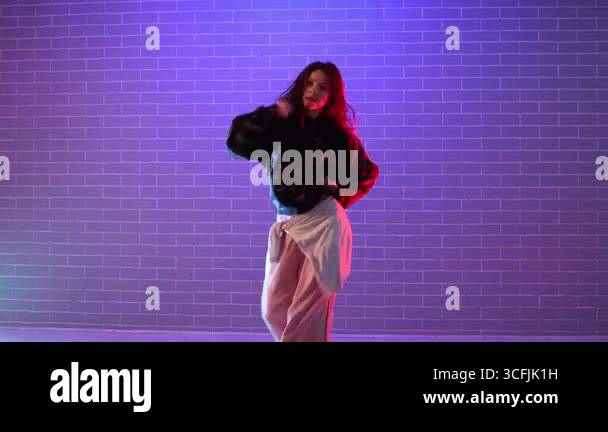 young girl choreographer dancing hip hop in neon lighting, woman ...