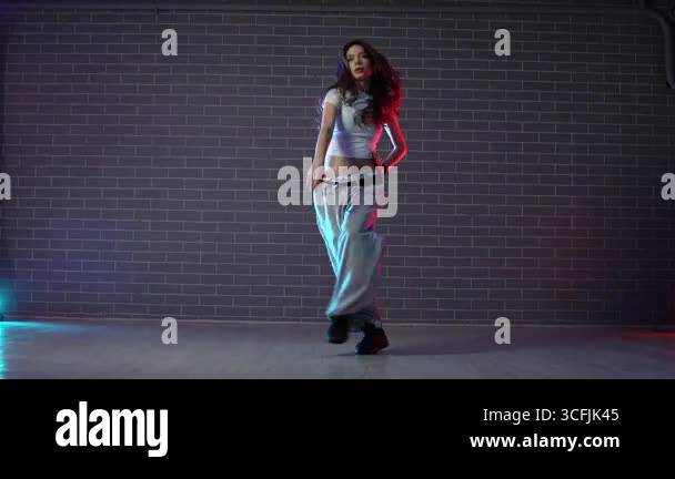 young girl choreographer dancing hip hop in neon lighting, woman ...