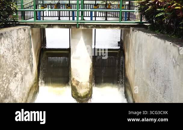A close-up video of an irrigation water gate with water flowing ...