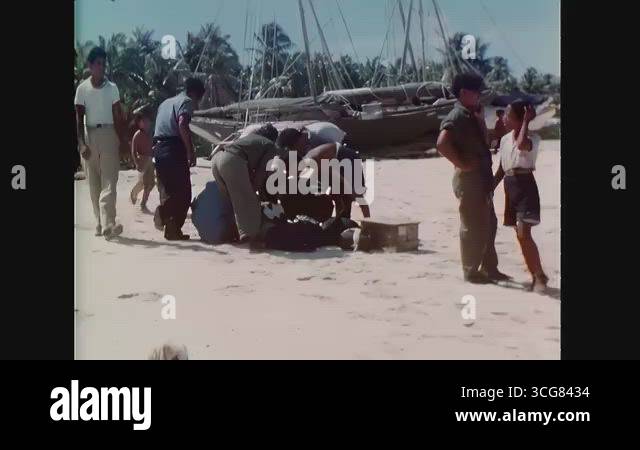 MARSHALL ISLANDS - 1947 - Indigenous people gather around gear on the ...