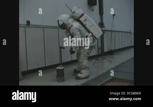 USA - 1970 - Apollo 13 astronauts practice using equipment to collect ...
