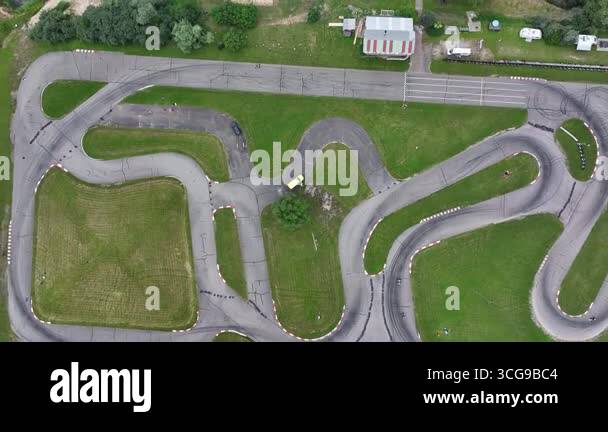 Aerial view of a go kart track with winding paths, a yellow kart in ...