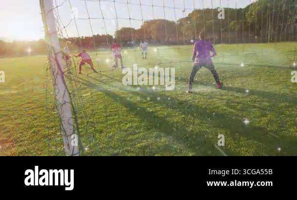 Receiving assist attacker dribbling toward soccer net aiming to score ...