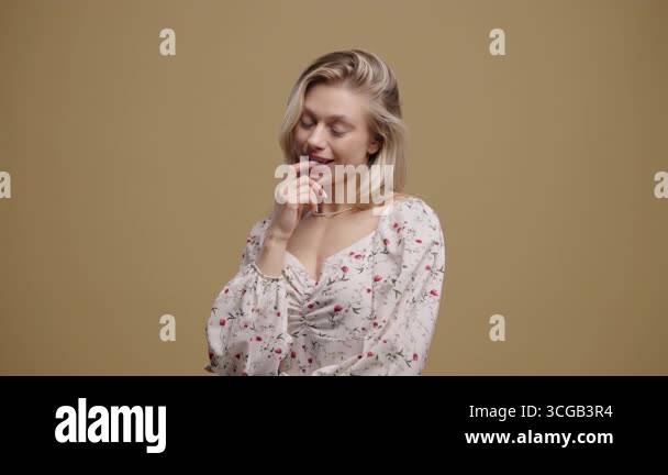 Playful Blonde Woman Smiling, Flirting To Camera On beige Studio ...