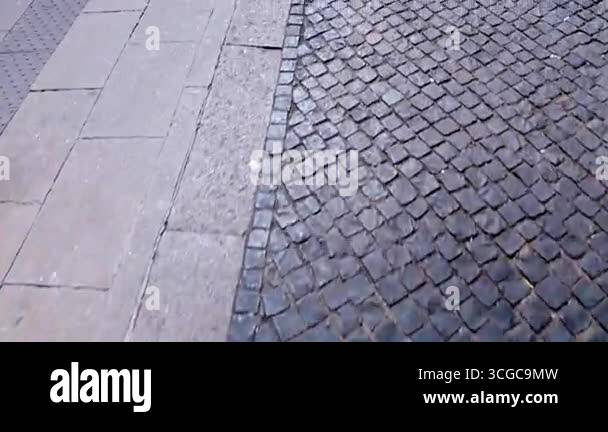 Close-up view of traditional cobblestone street in Rome, Italy, showing ...