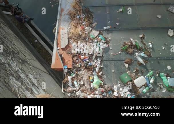 Rooftop littered with plastic bottles, containers, and debris alongside ...