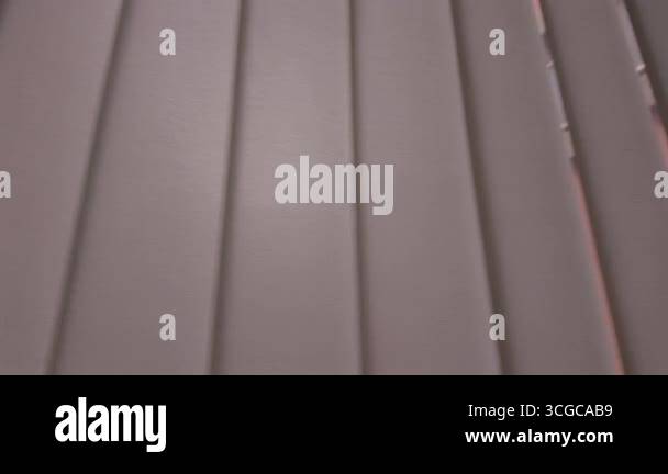 Closed vertical blinds with faint shadows and narrow light leaking ...