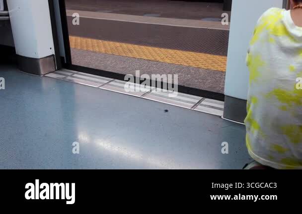 Closing subway train doors with visible station platform edge and ...