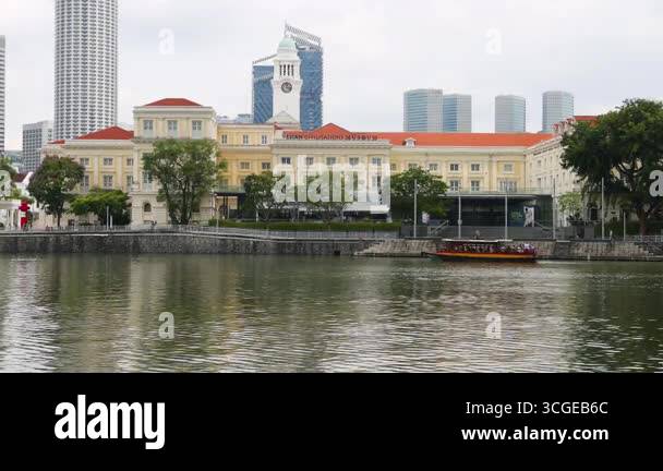 Tourist boat cruising along a city riverfront Stock Video Footage - Alamy