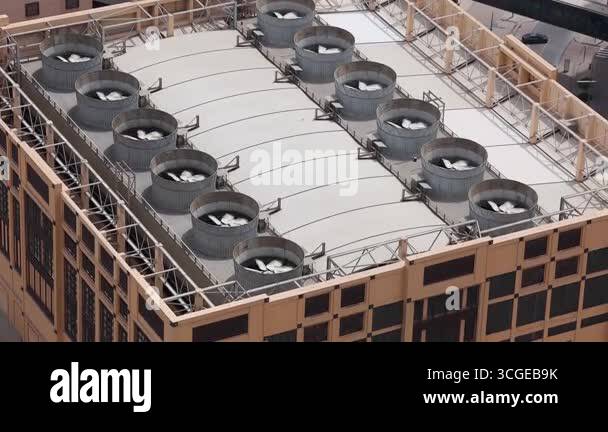 Cooling tower fans operating on a building roof Stock Video Footage - Alamy