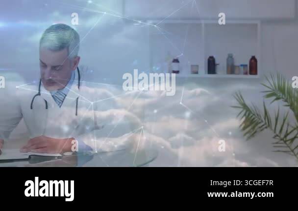Medical doctor leaning forward writing chart in consultation room while ...