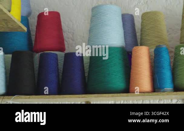 Assorted yarn cones in various colors including red, blue, green ...