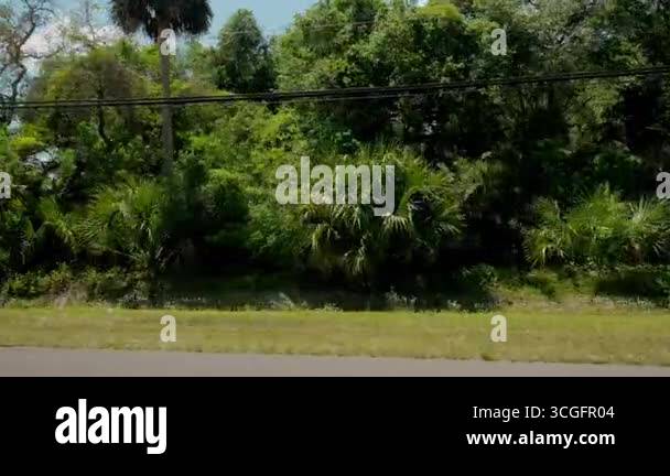 POV view from the passenger side in car driving on the suburbs road on ...