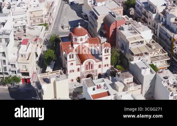 Aerial view of Agios Nikolaos, Crete, showcasing a red domed church ...