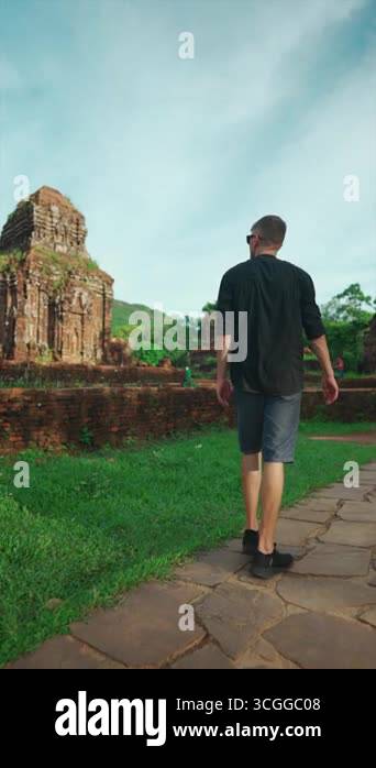 tourist man walking near MySon ruins in Vietnam, back view of male ...