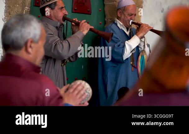 Shot through group of men playing drums, closeup of two men playing ...