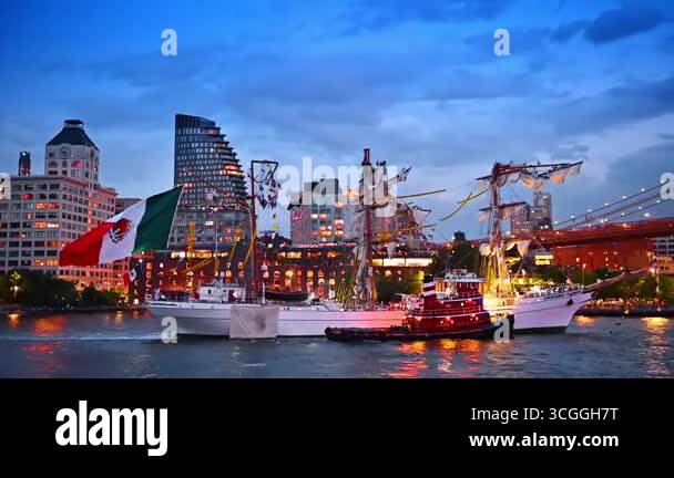 Wrecked ship with broken mast and tug boat move to the berth. Water ...