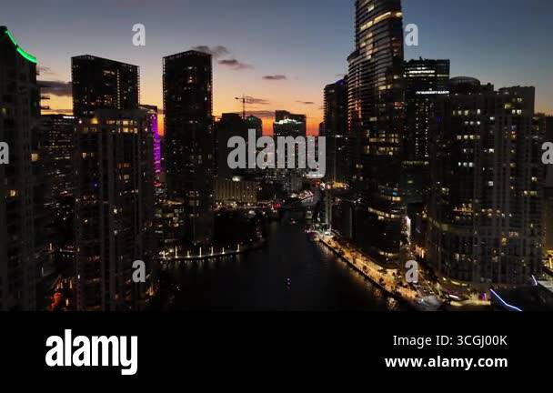 Miami skyline at dusk with colorful tropical sky and calm water, drone ...