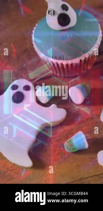 Glowing tunnel over ghost shaped halloween candies on wooden surface ...