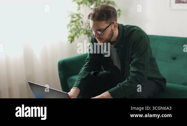 Focused bearded man in eyeglasses coding html and programming on modern ...