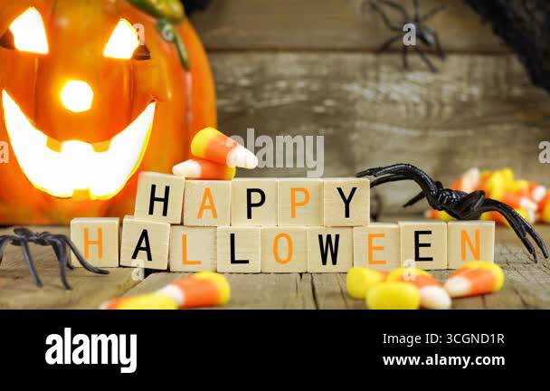Happy Halloween wooden blocks with flickering jack o lantern, candy ...