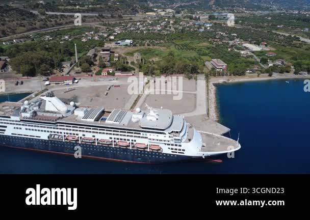 AIGIO,GREECE: 2025-07-20. A rusty old cruise ship is docked at a harbor ...
