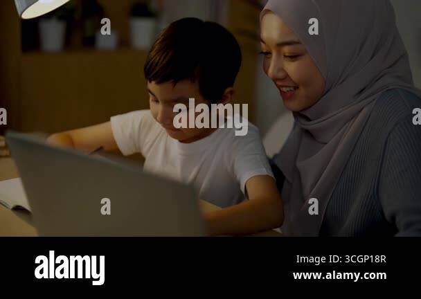 Islamic concept of 4k Resolution. Asian mother teaching son to write ...
