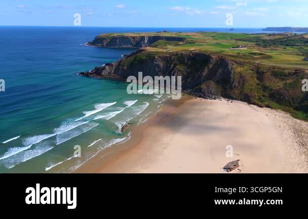Aerial View of Southern Coastal Beach with Waves and Green Countryside ...
